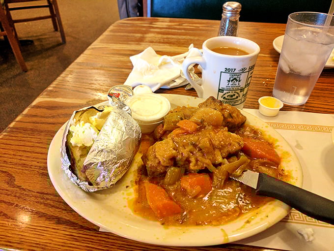 City chicken swimming in gravy alongside a baked potato in foil—comfort food that wraps around you like your favorite sweater.