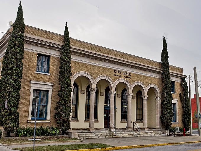 Palatka's City Hall exudes Mediterranean elegance with its arched entryway and cypress sentinels – civic pride wrapped in architectural distinction.