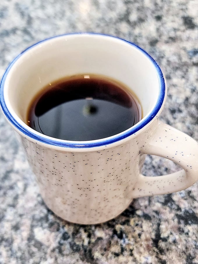 Their coffee comes in mugs designed for serious sipping, not dainty teacups – the blue rim a signature touch.