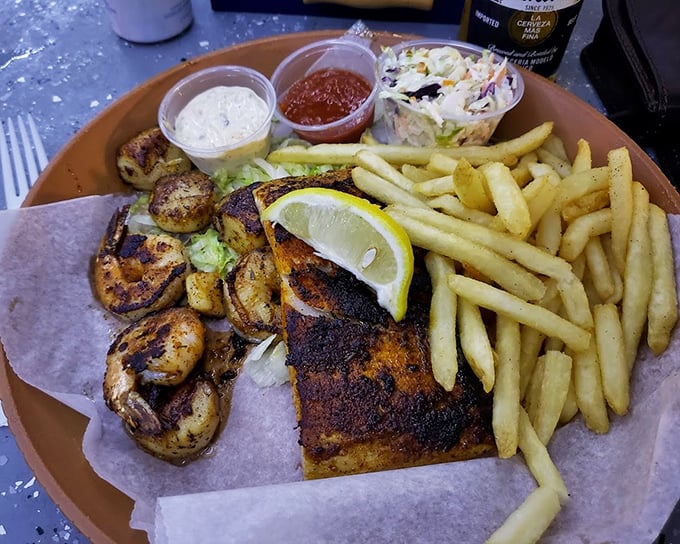 Blackened fish with a side of perfectly grilled shrimp—proof that sometimes the best things in life come on paper plates.