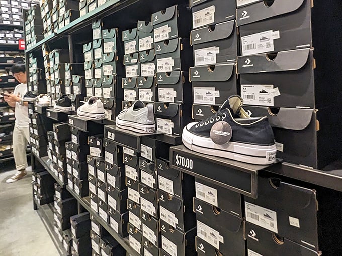 Converse shoes stacked like a monument to timeless cool. Chuck Taylors never go out of style, especially when they're marked down to $70.