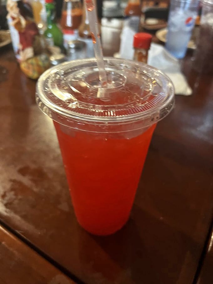 This vibrant red drink isn't just refreshing; it's like childhood summers distilled into liquid form, served with a straw for time travel.