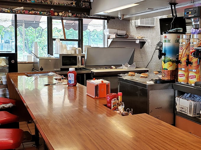 Behind the counter at Brownie's—where burger magic happens on well-seasoned grills that hold decades of delicious secrets in their seasoned surfaces.