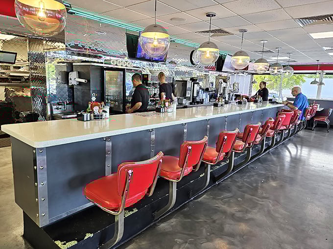 The counter seating—where solo diners become temporary family and coffee refills arrive before you realize you need one.