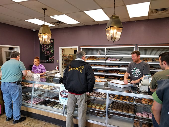 The morning rush at Milton's has its own choreography—customers pointing, staff boxing, everyone united in pursuit of the perfect donut.