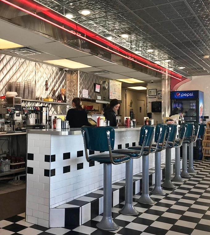 The counter stools aren't just seating—they're front-row tickets to the greatest show on earth: American short-order cooking in all its choreographed glory.