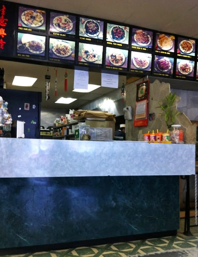 Behind the counter magic happens with military precision – where dishes come to life under the watchful eyes of illuminated menu photos.