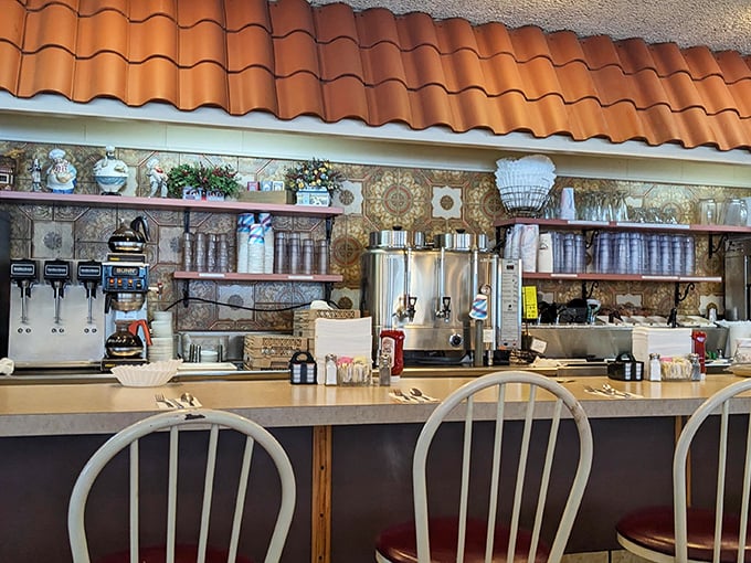 The counter area—where coffee flows freely, regulars exchange local gossip, and the breakfast specials are announced like breaking news.