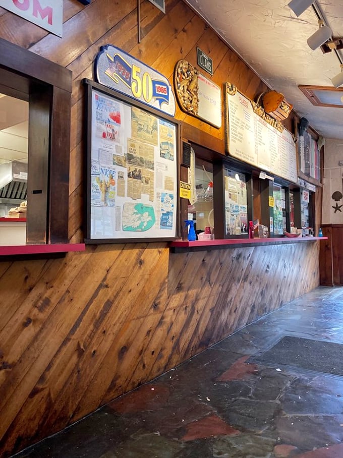The ordering counter – where dreams are placed and numbers are given. Behind that wood paneling, seafood magic happens.
