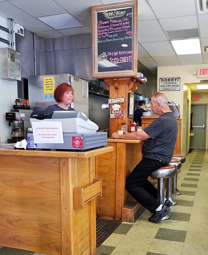 The counter—where solo diners become temporary family and coffee refills flow like conversation between old friends.