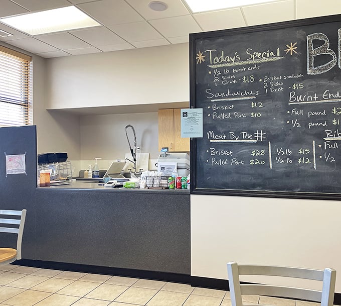 The daily specials board—where barbecue dreams are made and difficult decisions begin. Half-pound of brisket or full rack of ribs? Why not both?