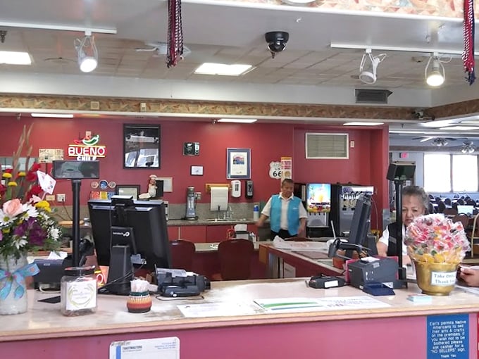 The bustling counter where magic happens—coffee flows freely and orders fly while Route 66 memorabilia watches from above.