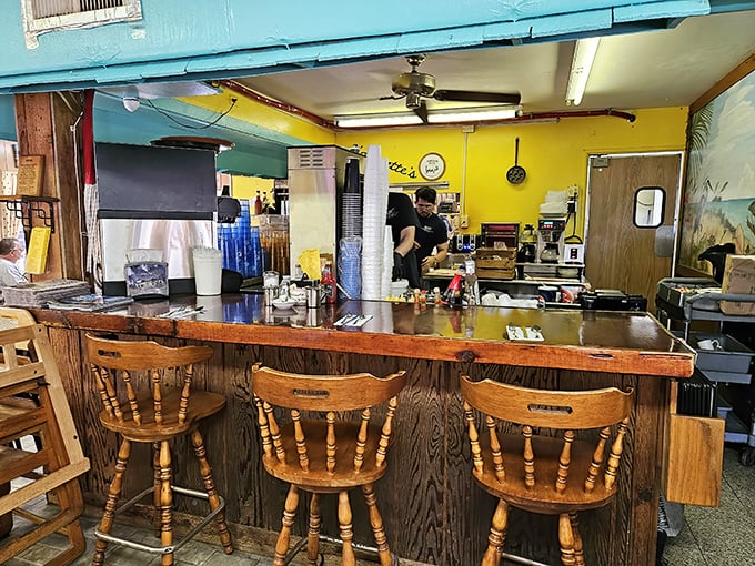 The counter seating offers front-row views to the breakfast ballet – where orders are called, plates are filled, and morning miracles happen with choreographed precision.