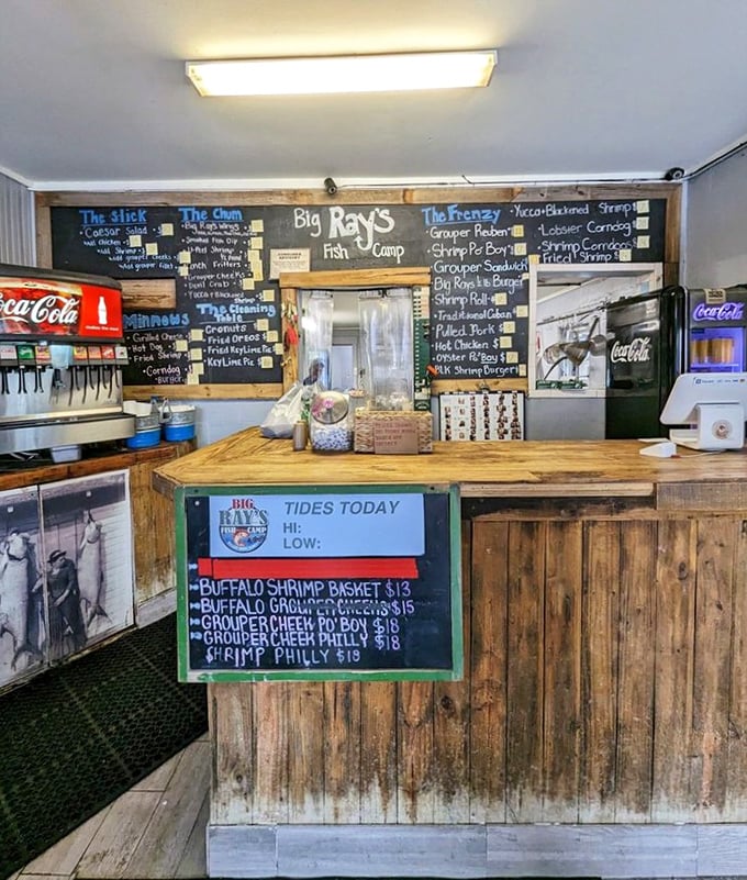 The ordering counter: where dreams become reality. Notice the tide times posted—because fresh fish and good timing go hand in hand.