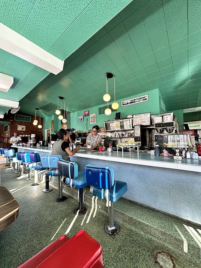 The counter is where the magic happens. Those blue stools have supported generations of diners seeking breakfast salvation.