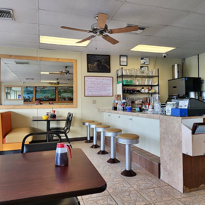 The counter seating offers front-row tickets to the breakfast show, where coffee mugs are never empty and everyone feels like a regular.