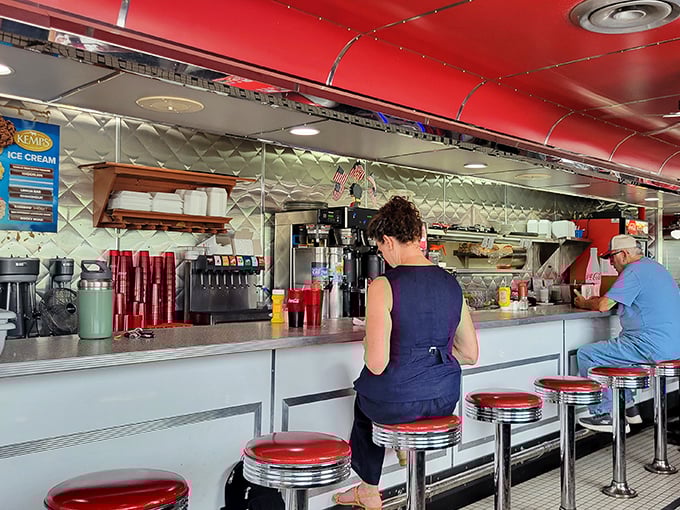 Classic counter seating where conversations flow as freely as the coffee refills throughout the day.