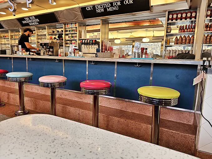 The counter seats—where breakfast aficionados earn their stripes. Those colorful stools have witnessed countless first sips of morning coffee.