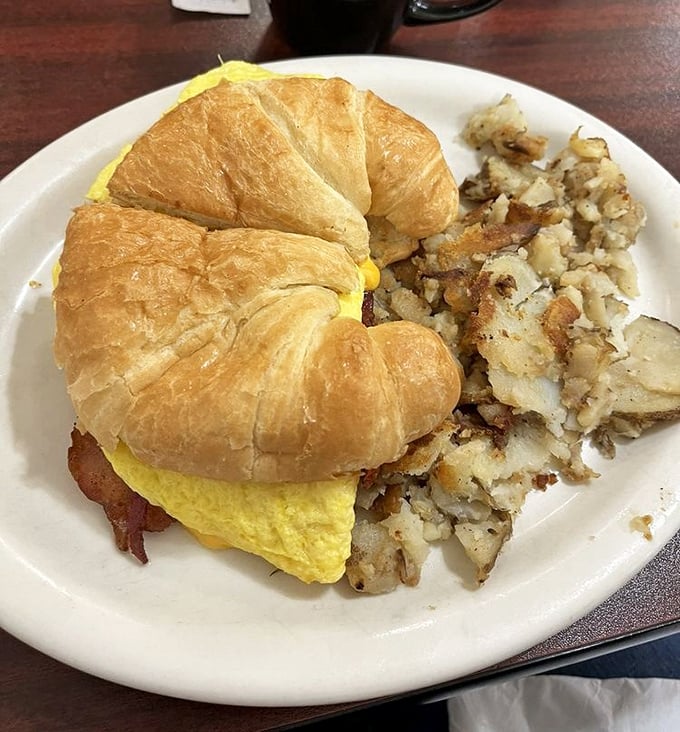 This croissant sandwich doesn't just say "good morning"—it delivers a full breakfast sermon with eggs as the gospel.