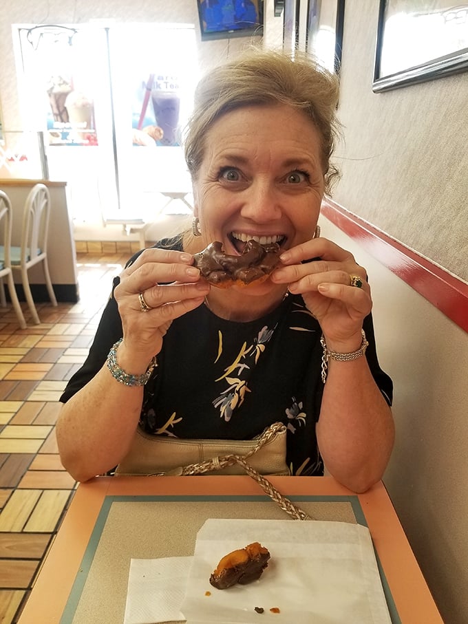 Pure donut joy captured in real-time – the universal expression that says "why did I wait so long to try this place?"