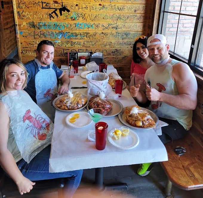 Happy diners in their plastic bibs – the universal uniform of serious seafood enthusiasts who understand good food is worth getting messy for.