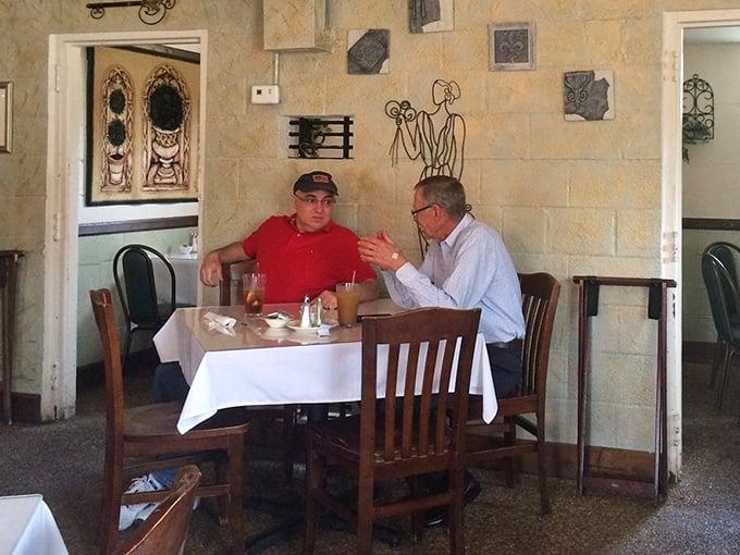 Every great restaurant has corners where conversations flow as easily as the sweet tea. These stone walls have heard decades of local stories.