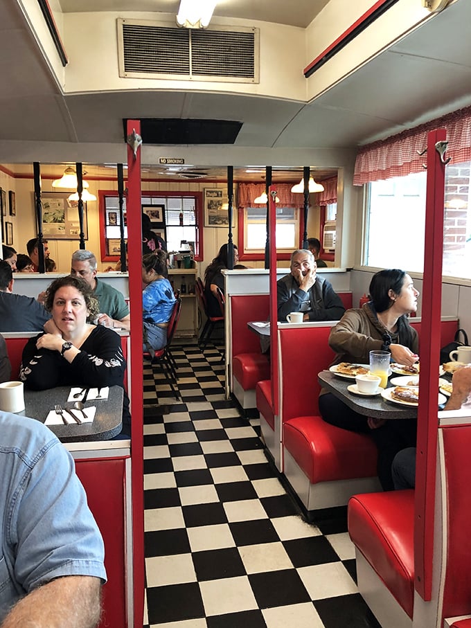 The classic diner aisle—where servers perform the daily ballet of coffee pots and plates while regulars exchange news across checkered floors.