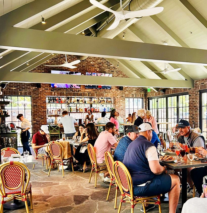 The bustling dining room captures that magical moment when strangers become friends over shared plates and flowing conversation.