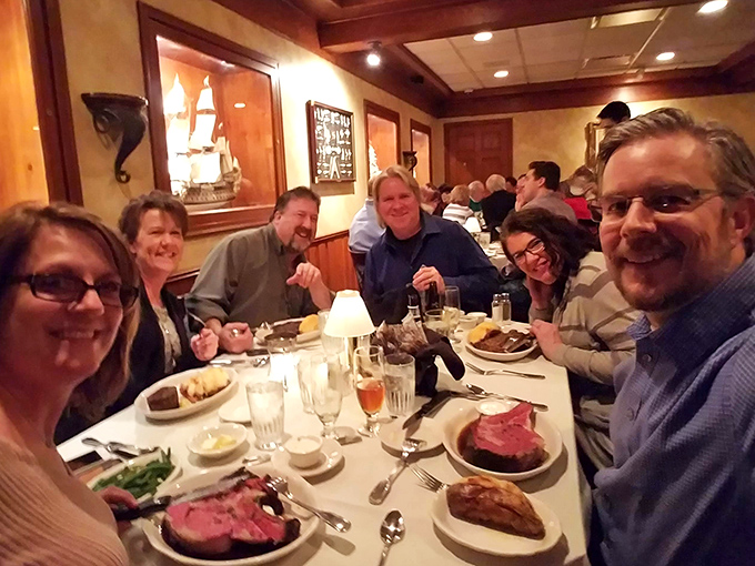Happy diners enjoying the kind of meal that turns strangers into friends and friends into family. Prime rib diplomacy at its finest.
