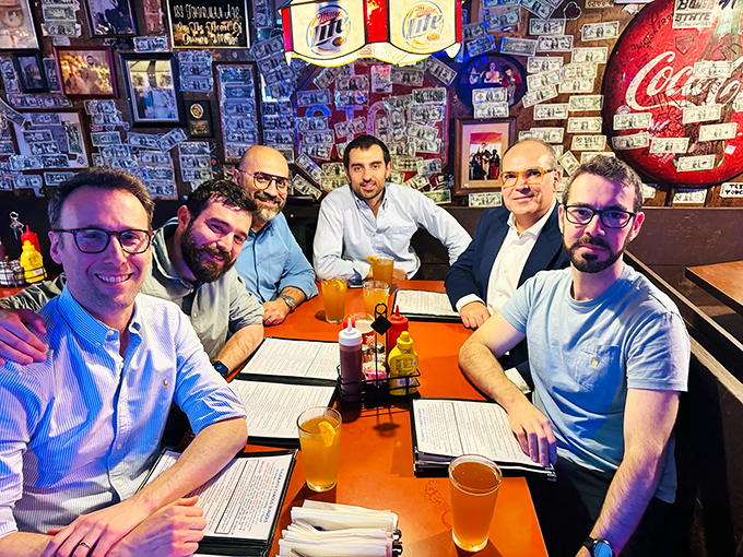 The dining room buzzes with the energy of friends gathered around tables, united by the universal language of great food.