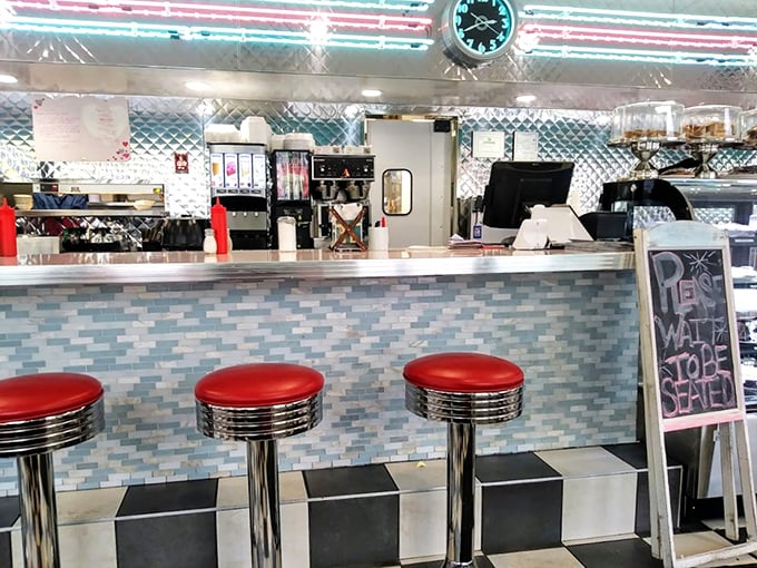 The counter where regulars become family and first-timers become regulars. Those red stools have heard decades of stories.