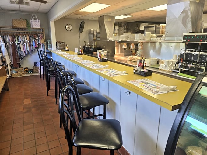 The counter view reveals the stage where comfort food magic happens, each stool a front-row seat to culinary theater.