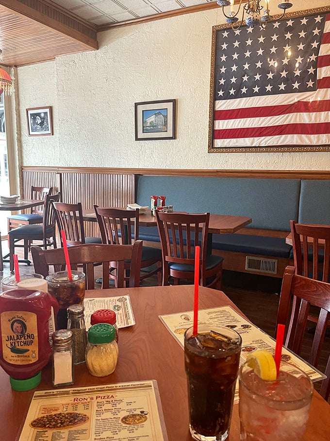 The dining room feels like it's been welcoming friends since before you were born. Those blue booth seats have heard decades of good conversations.