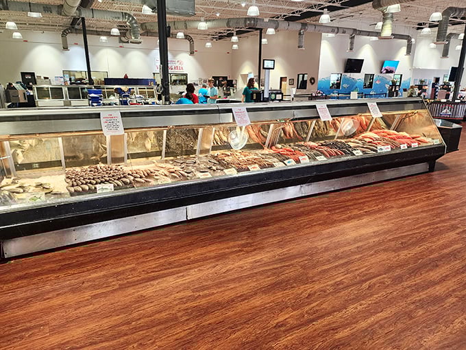 The seafood market display case—where tomorrow's dinner plans are born and diet resolutions go to die. Ocean bounty in all its glory.