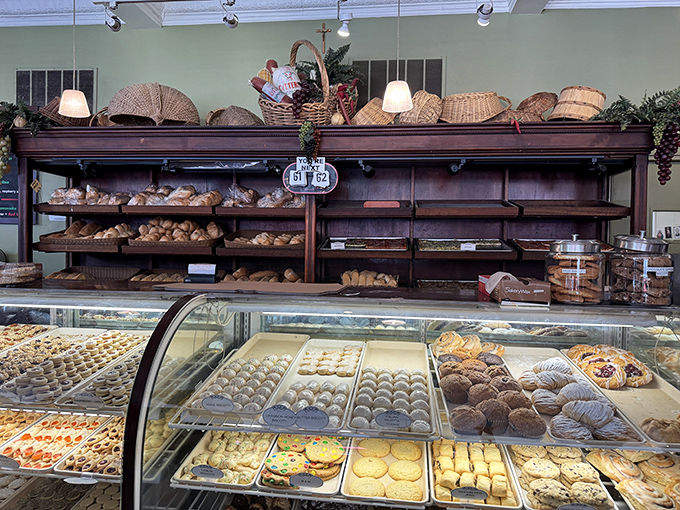 The bread and pastry display—where carb dreams come true and willpower goes to die, all beneath charming wicker baskets that whisper "you're in good hands."