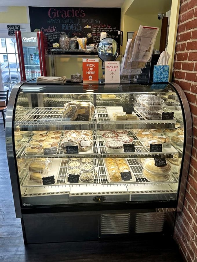 The display case at Gracie's – where pastry dreams come true and diet plans go to die in the most delicious way possible.