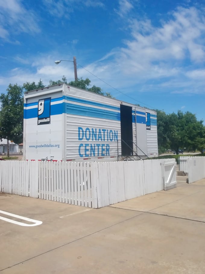 The donation center: where the circle of thrift begins, a humble outpost transforming unwanted items into community opportunities behind its white picket fence.