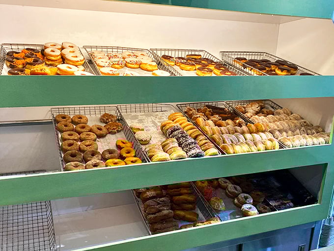 The donut display case—or as I call it, "The Wall of Temptation." Each tray offers a different path to happiness, all equally valid.