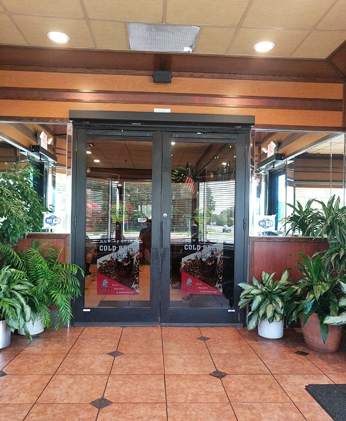 The entrance welcomes you with lush greenery and gleaming doors—like the pearly gates of comfort food heaven, minus the judgment about your appetite.
