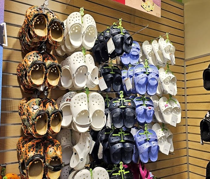 The Crocs rainbow—comfort's comeback kid displayed in every hue imaginable. Love them or hate them, your feet will thank you after a day of outlet exploration.