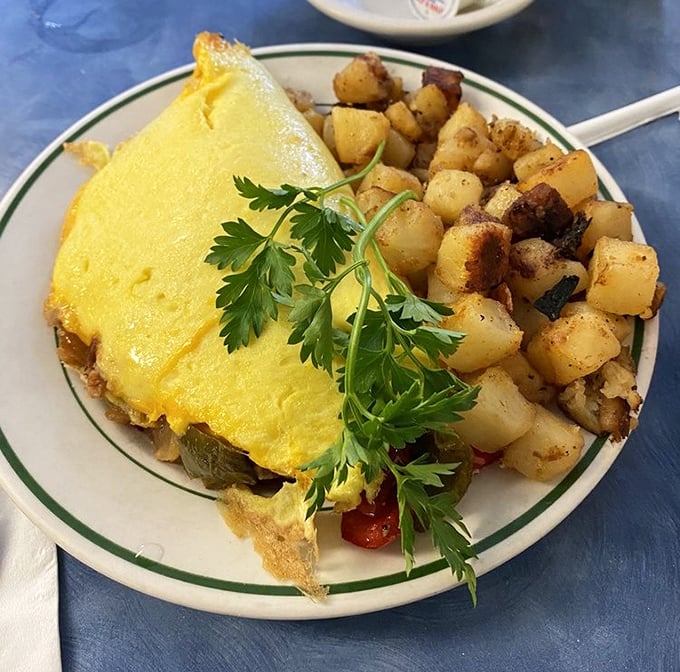 This omelet doesn't just contain vegetables – it embraces them in a fluffy yellow hug that makes healthy eating feel like cheating.