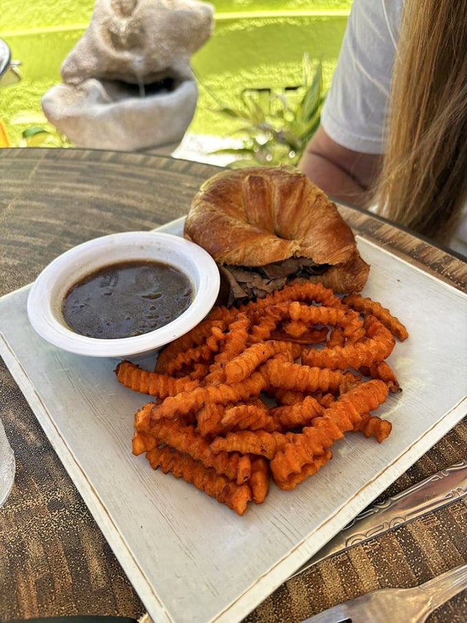 Sweet potato fries and a sandwich—proof that lunch at a breakfast place isn't settling, it's discovering a whole new dimension of deliciousness.