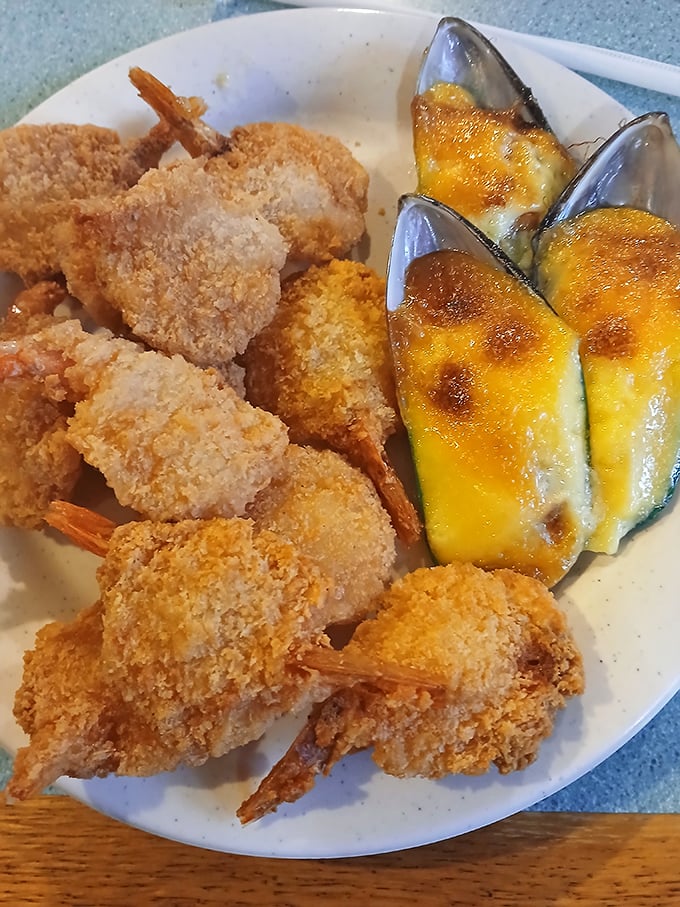 Golden-fried shrimp standing at attention next to cheesy baked mussels – seafood that's dressed for a special occasion.