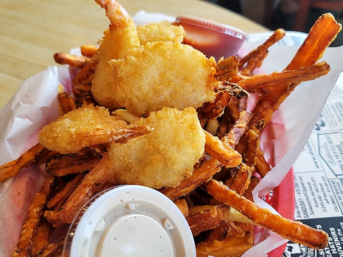 Golden-battered shrimp nestled among sweet potato fries – proof that sometimes the best vacation memories come served in a paper-lined basket.