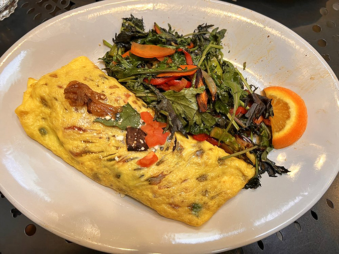 This omelet doesn't just contain vegetables—it celebrates them in a fluffy egg embrace alongside a garden's worth of fresh greens.