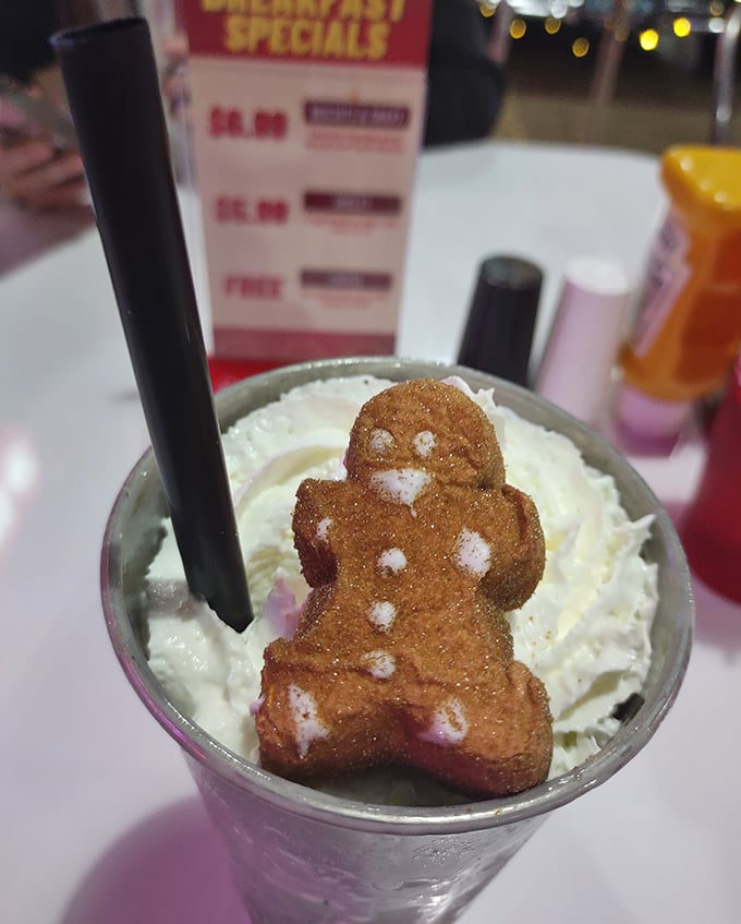 A milkshake topped with a gingerbread man—because sometimes dessert needs its own dessert. Childhood joy in a glass.