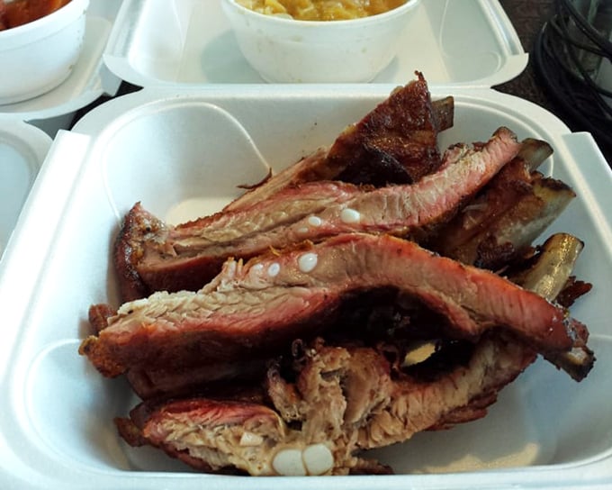 Ribs with that perfect pink smoke ring—visual evidence of the low-and-slow cooking method that defines great barbecue.
