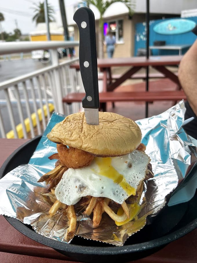 The Hangover Burger: where breakfast meets lunch in a glorious union topped with a sunny-side-up egg that says "good morning" to your taste buds.