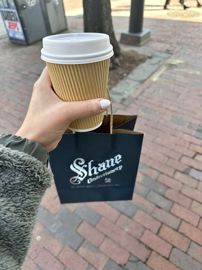 That's not just a coffee cup and shopping bag—it's the trophy and evidence of a successful candy expedition through Philadelphia's sweetest historical landmark. 