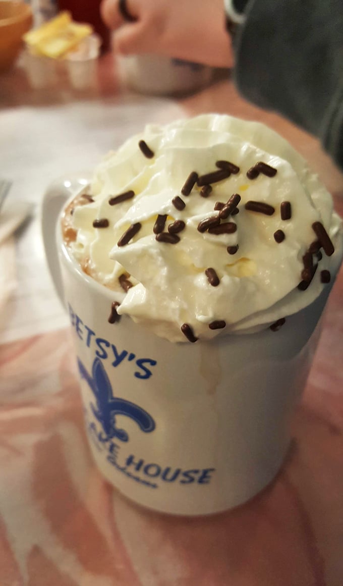 Hot chocolate topped with enough whipped cream to make a barista jealous.